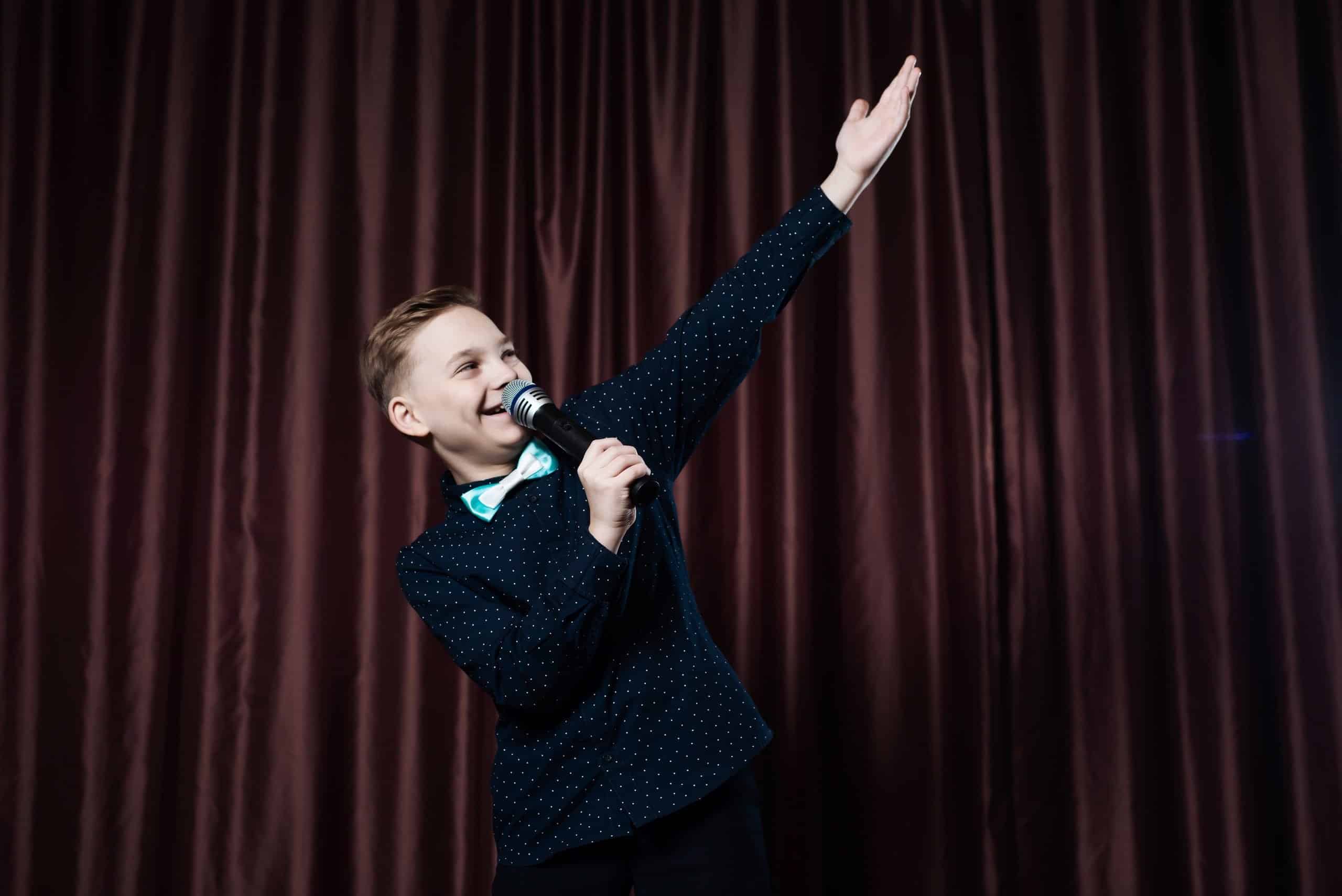 little boy singing in microphone. child in karaoke - Confident Voice Studio
